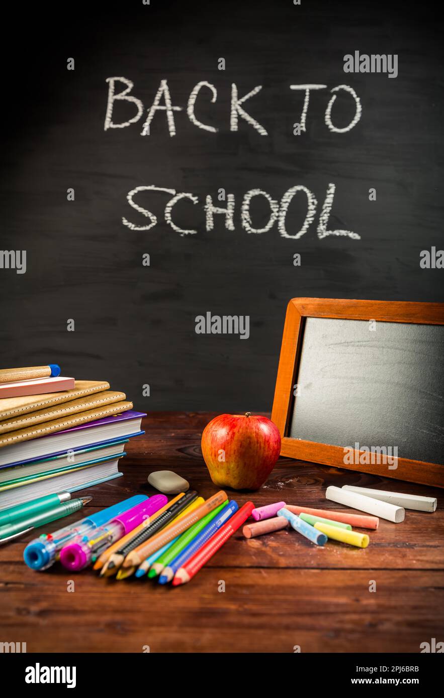 Pile of book and exercise books with school applies and apple snack ...
