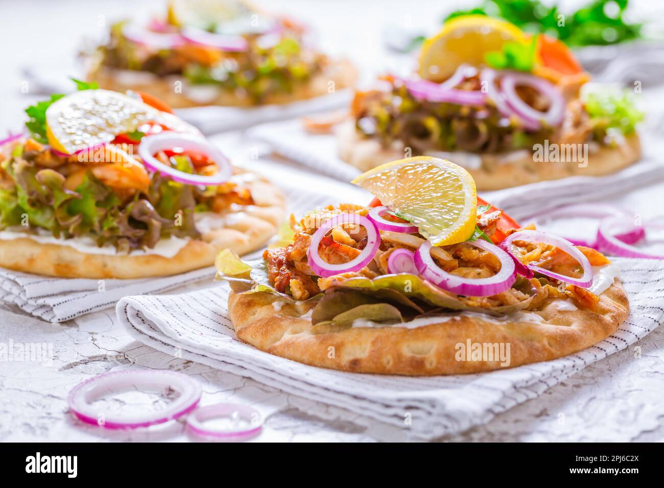 Greek gyros meat with pita flat bread, vegetables and onions and ...