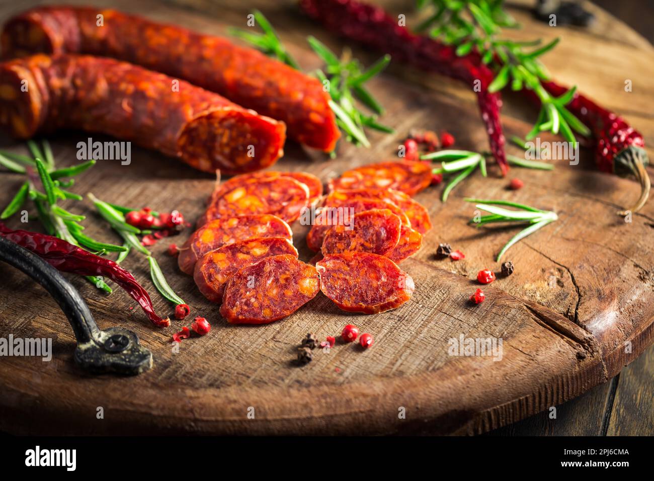 Red Spanish chorizo sausage with herbs and spices on wooden cutting ...