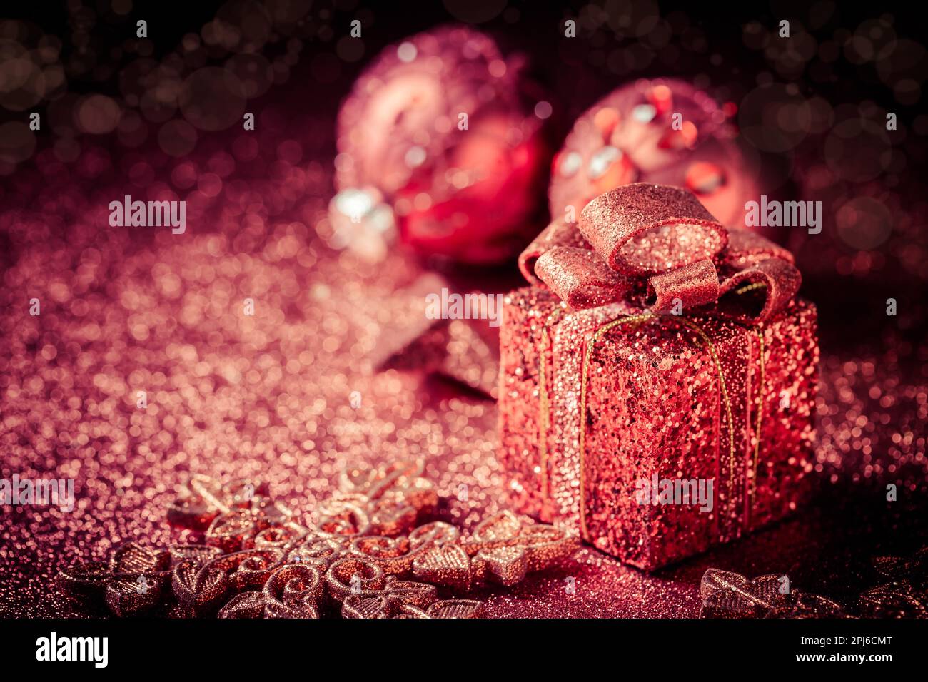 Christmas glitter ornaments and present box on dark background Stock ...