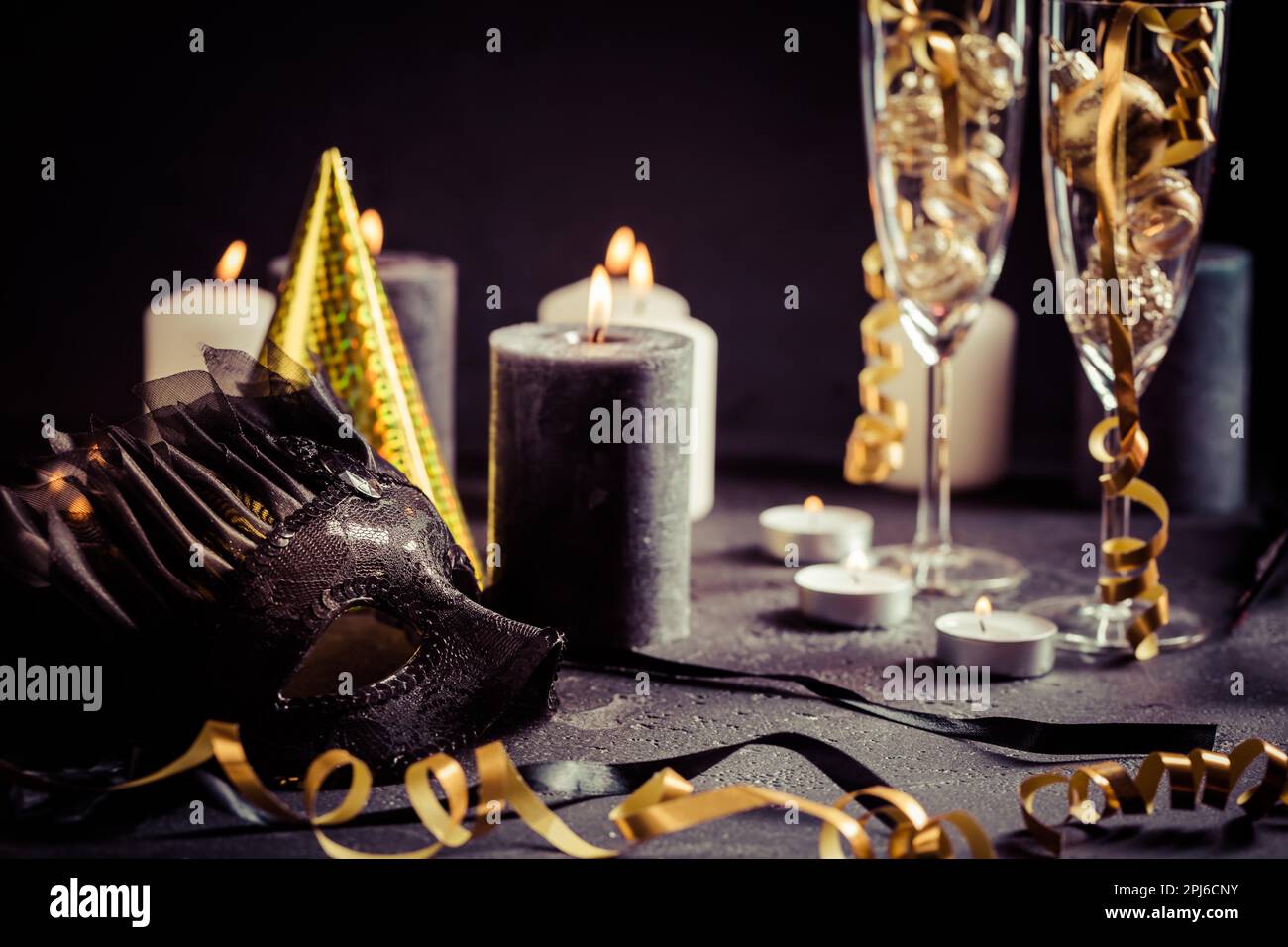 Party still life with carnival mask, candles on black background Stock ...