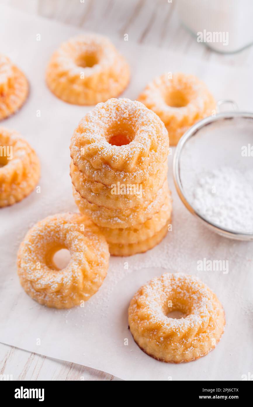 Small sponge cakes with cottage cheese. Ring cakes on white background ...