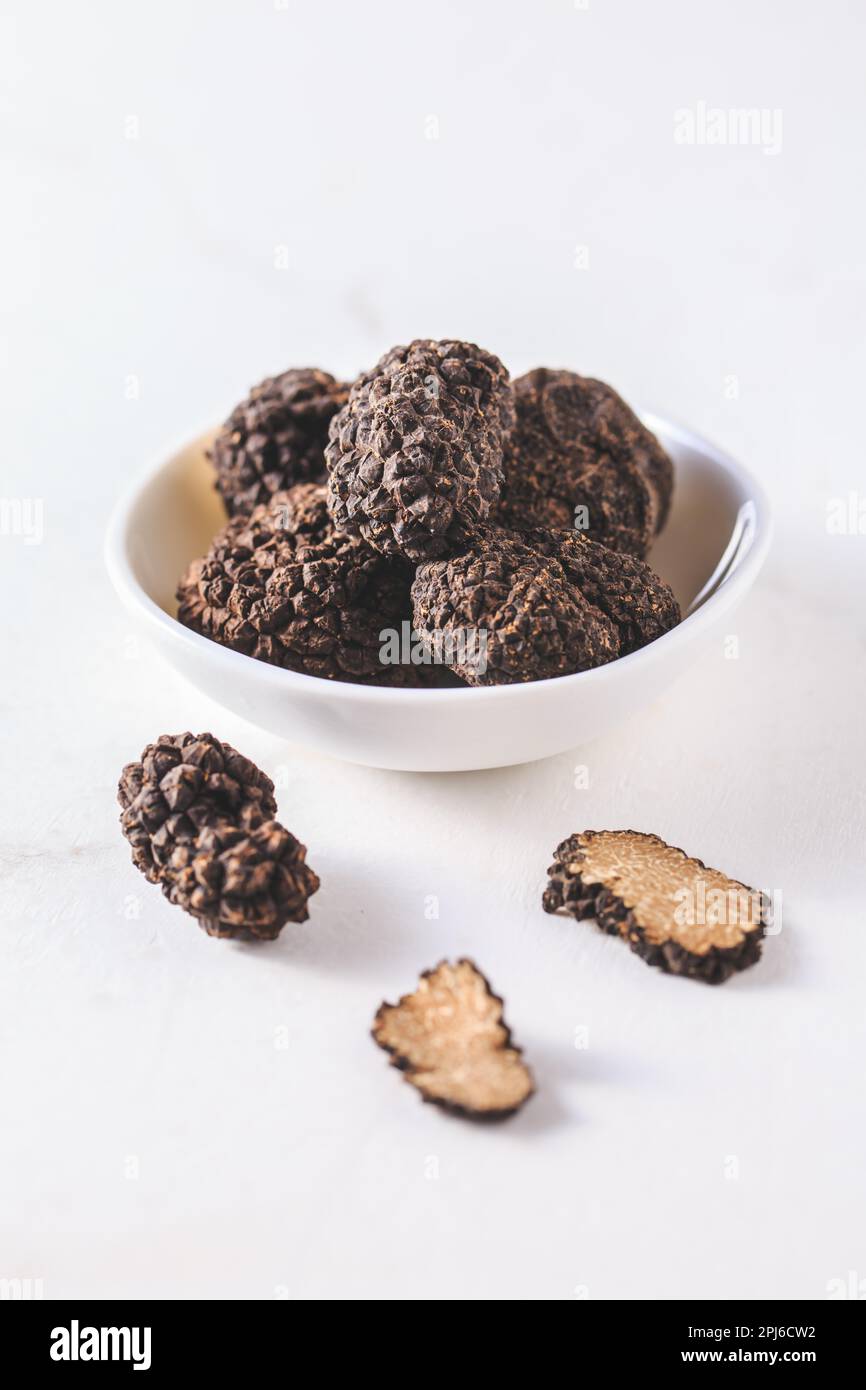 Black truffle in bowl on white background, cooking delicacy Stock Photo ...