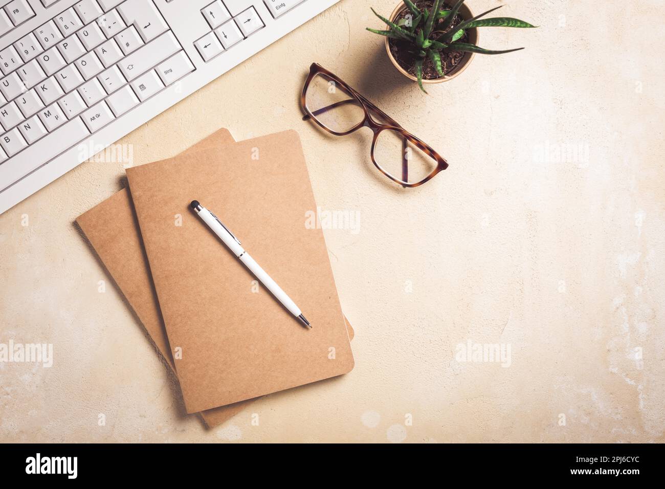 Modern office desk table with laptop computer, notepad, tablet, plant ...