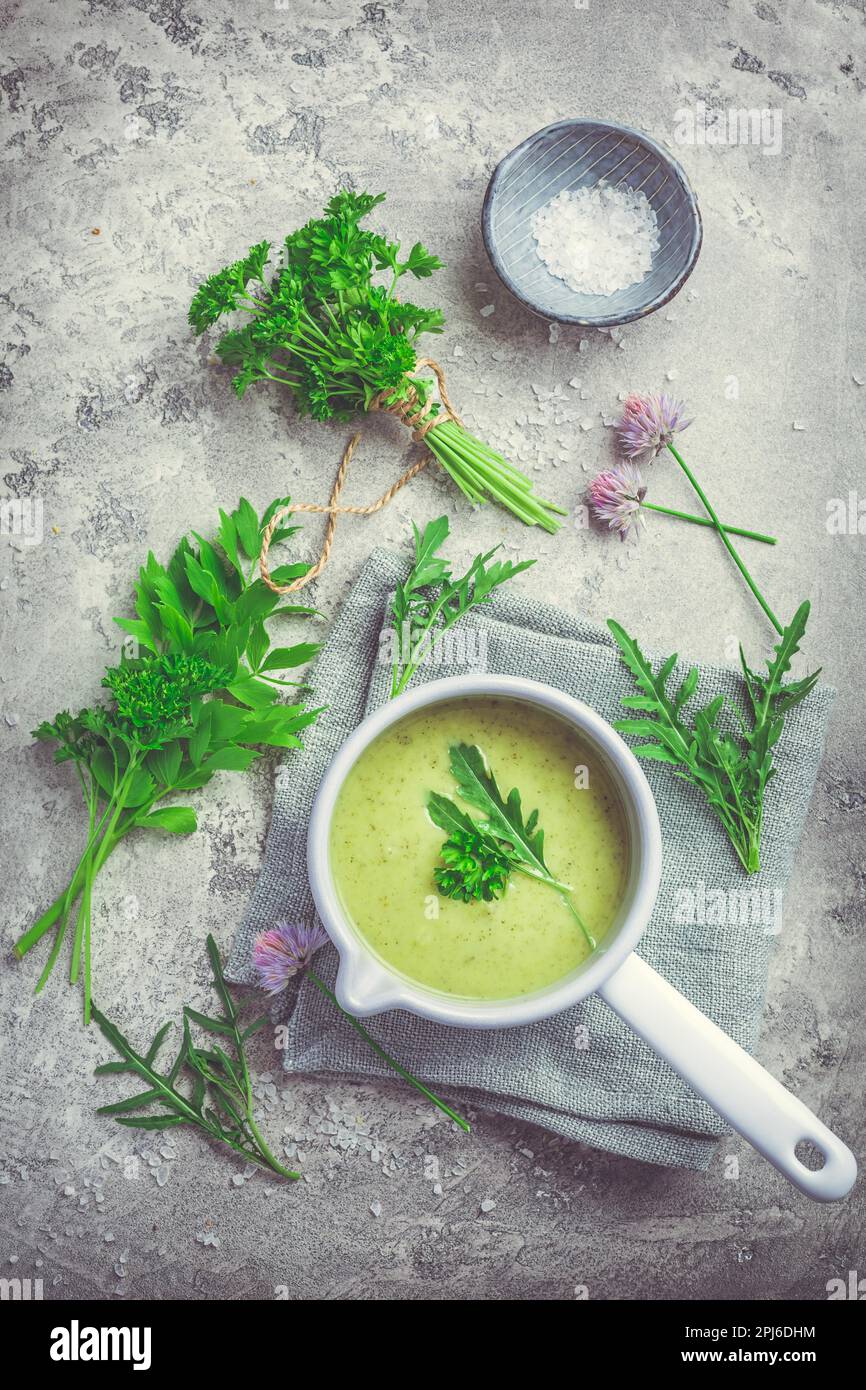 Healthy homemade green herb soup in pot made from local wild and garden ...