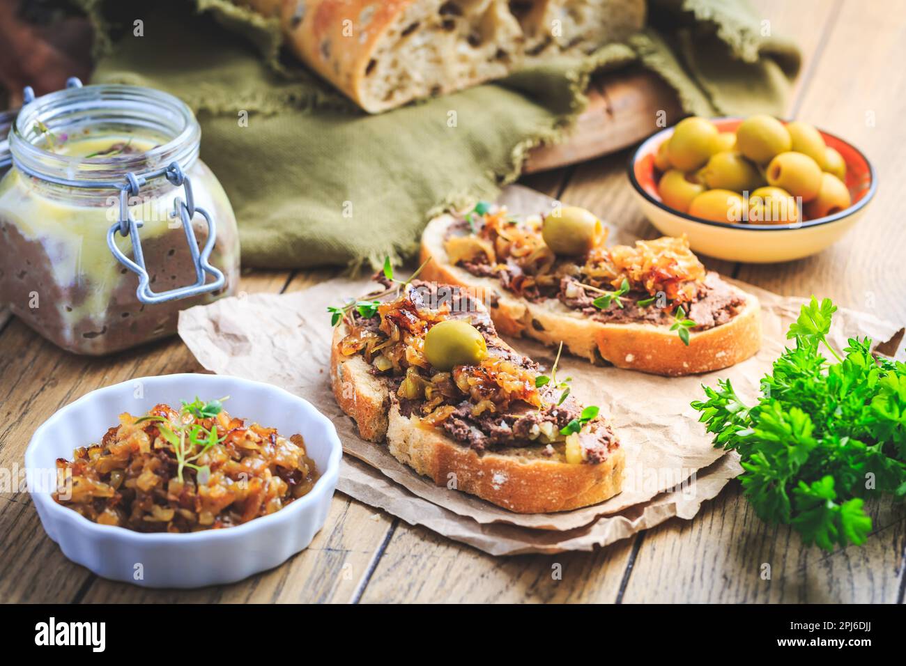 Fresh homemade chicken liver pate on ciabatta bread with roasted onions ...