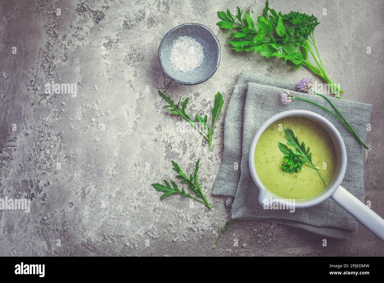 Healthy homemade green herb soup in pot made from local wild and garden ...