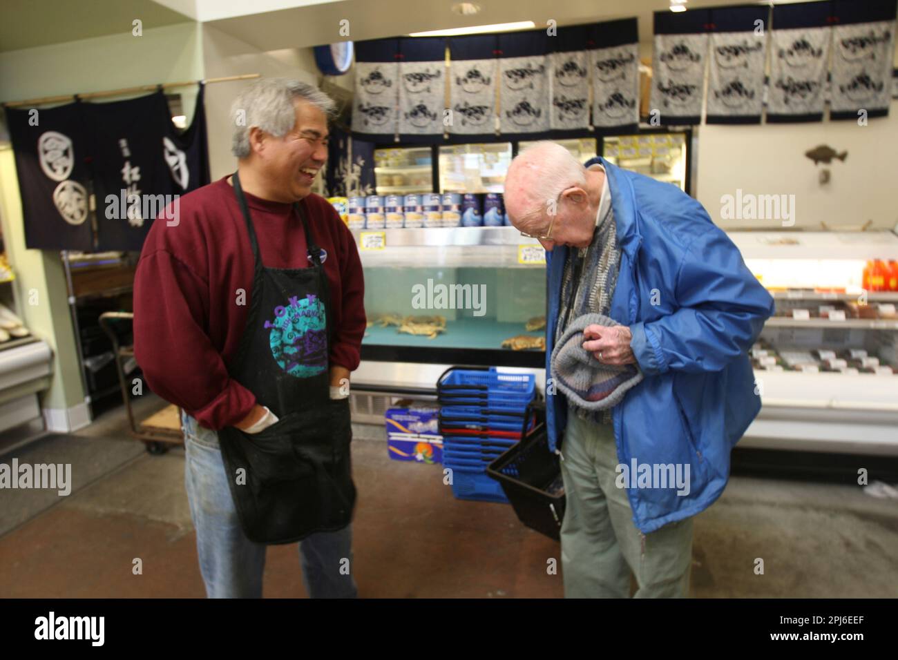 Lee Nakamura (left,) laughs as customer Leonard Marks (right) of ...