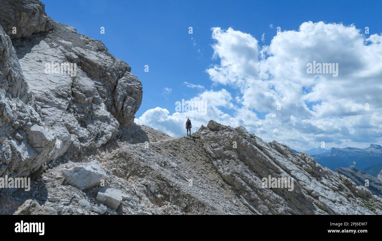 Tourist with equipment on the via ferrata trail in the Dolomites ...