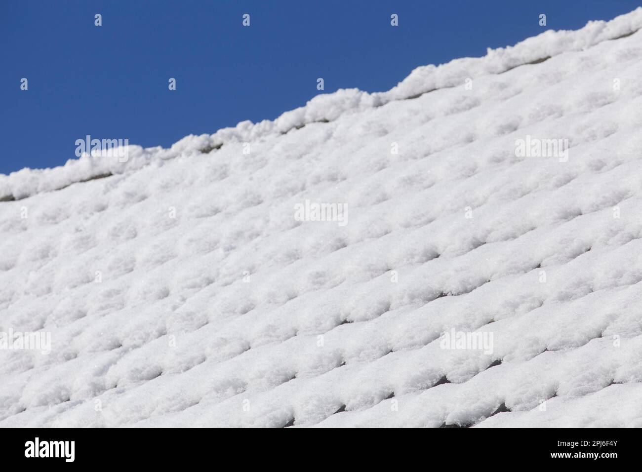 Snowy roof tiles on a roof in winter, wallpaper, Germany Stock Photo ...