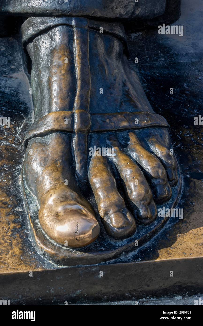 The huge foot of the bronze sculpture of Gregory of Nin and the shiny ...