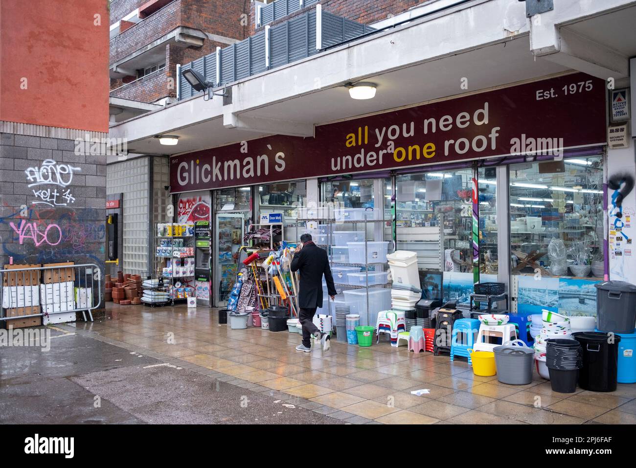 People out and about in the rain outside shops on Watney Street in ...