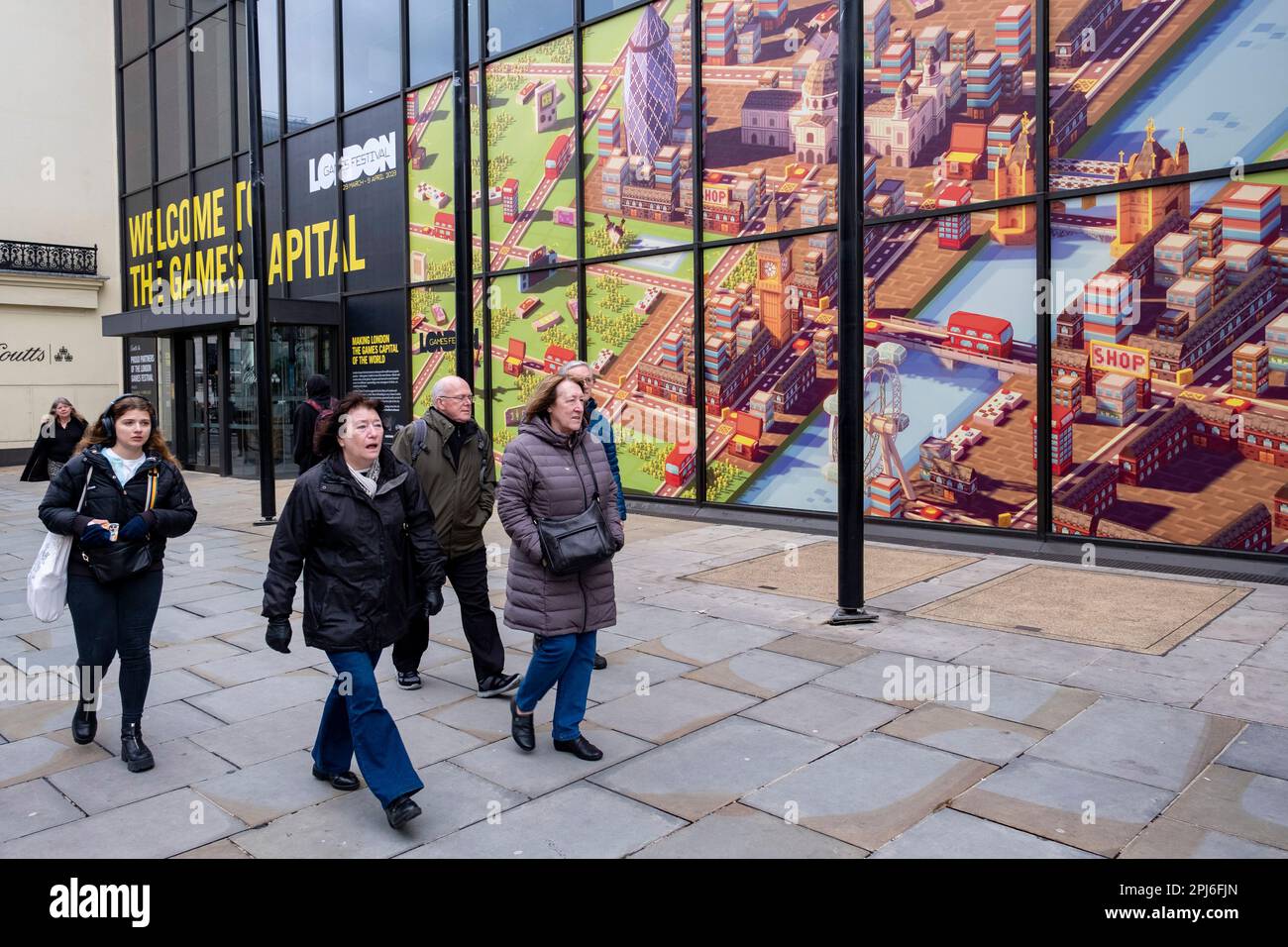 Passers by interact with a large scale computer game illustration of ...
