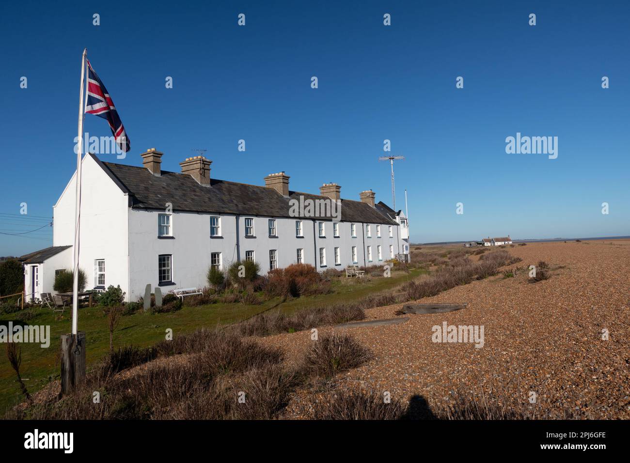 Row of white cottages at the remote suffolk hamlet at Shingle Beach ...
