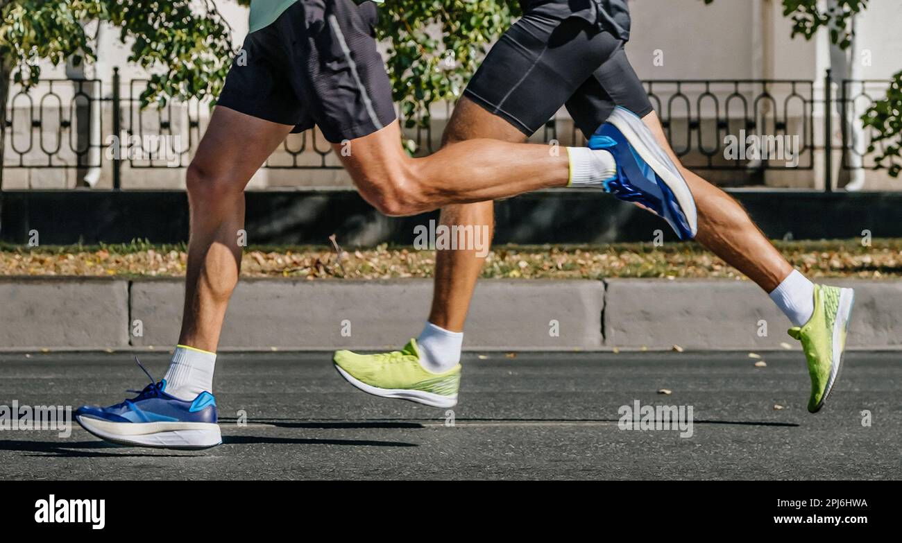 legs two male runners running city marathon race, athletes jogging on ...