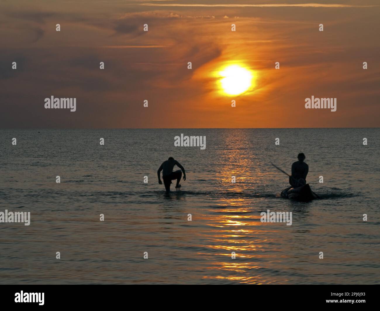 At the North Sea, people in the water, sunset Stock Photo - Alamy