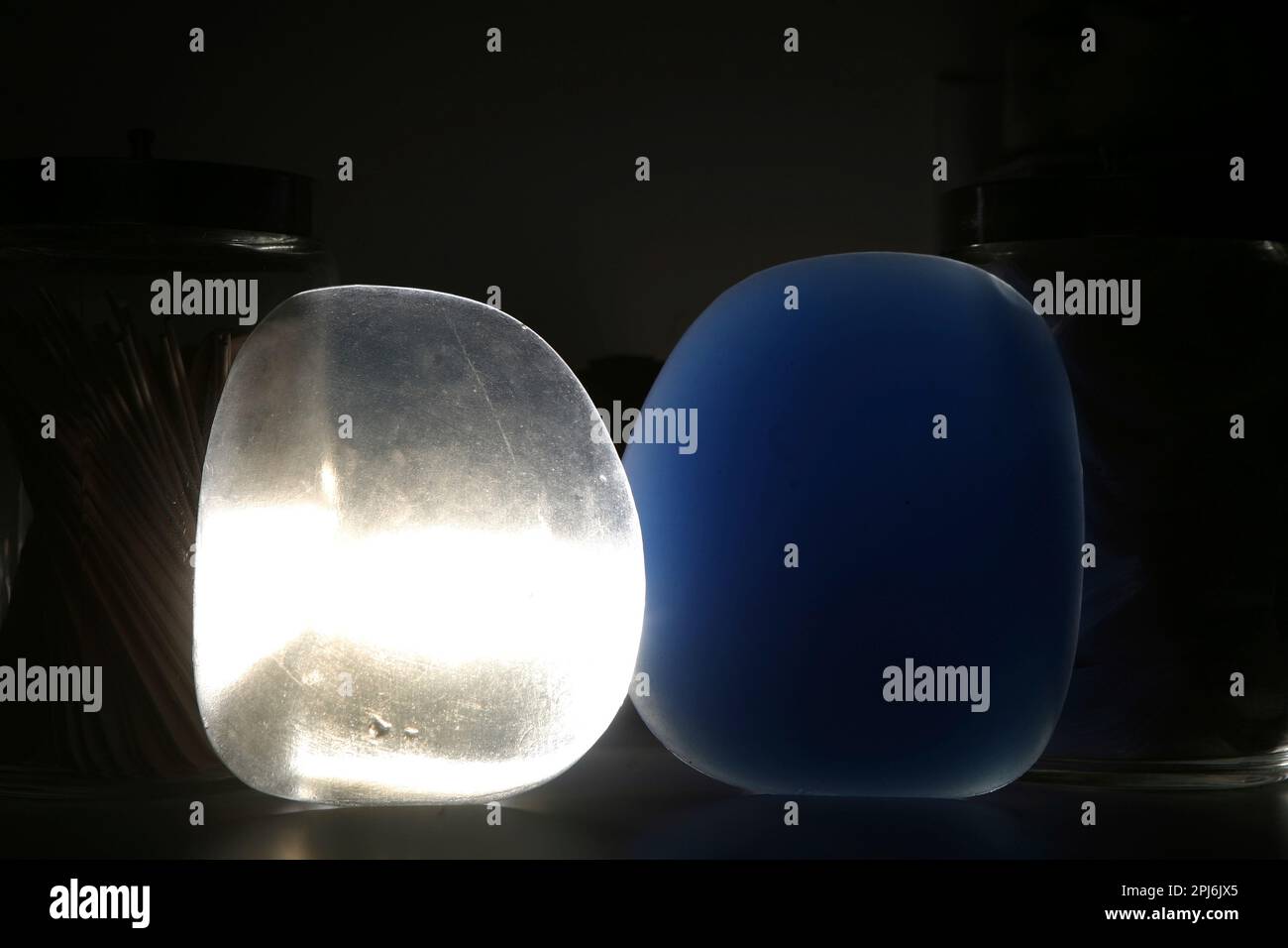 Silicone pectoral implants one in a semi-clear champagne color and one ...