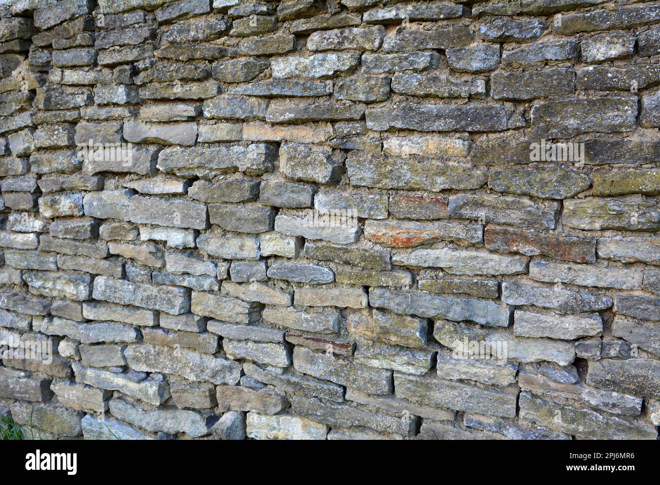 Old wall built of natural stone tiles Stock Photo - Alamy