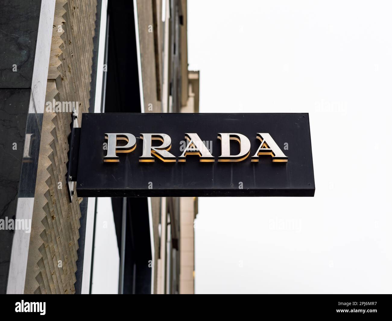 Prada logo sign on a building exterior in a shopping street. The ...