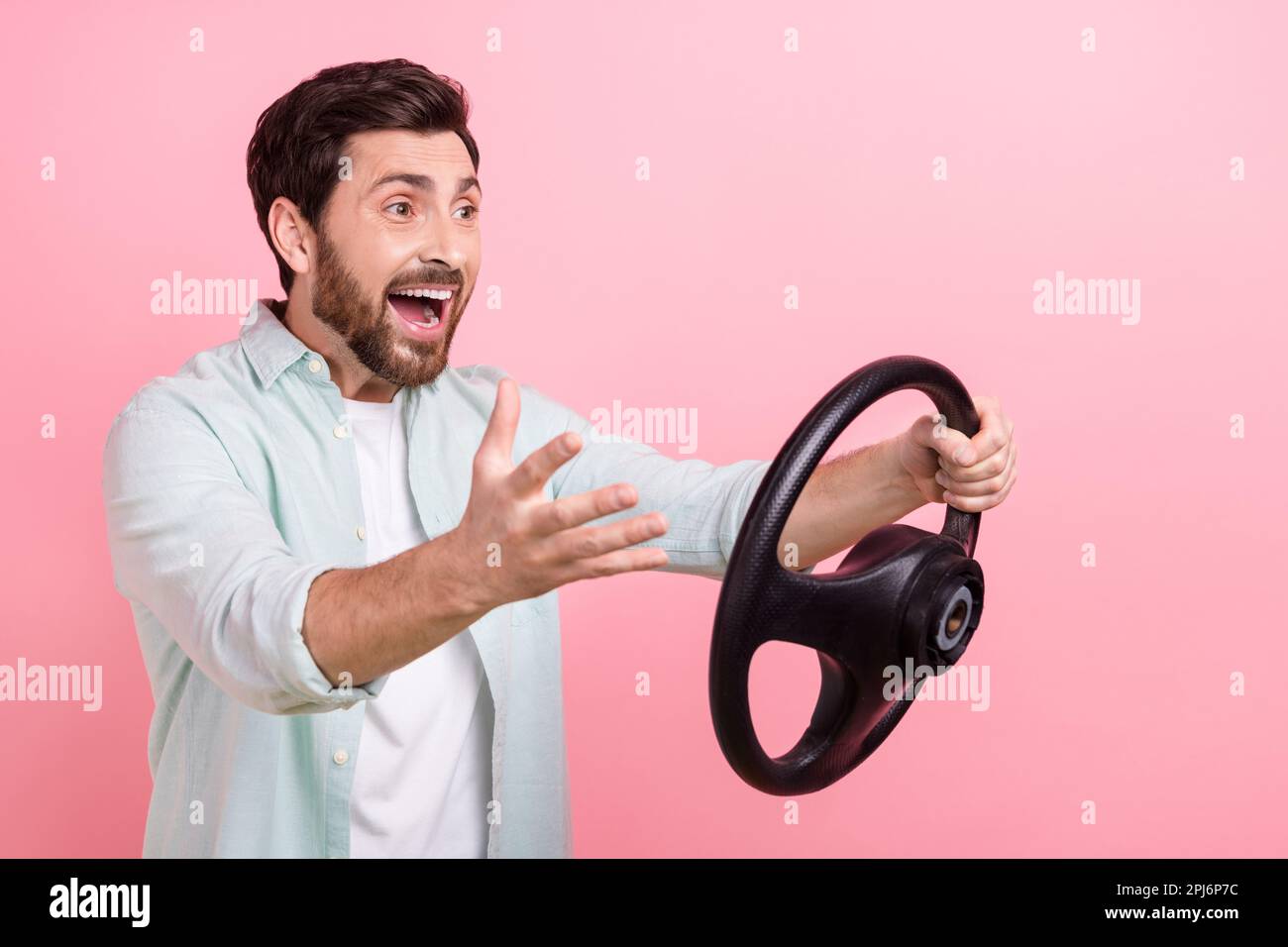 Photo of unexpected crazy angry excited guy hold steering wheel ...