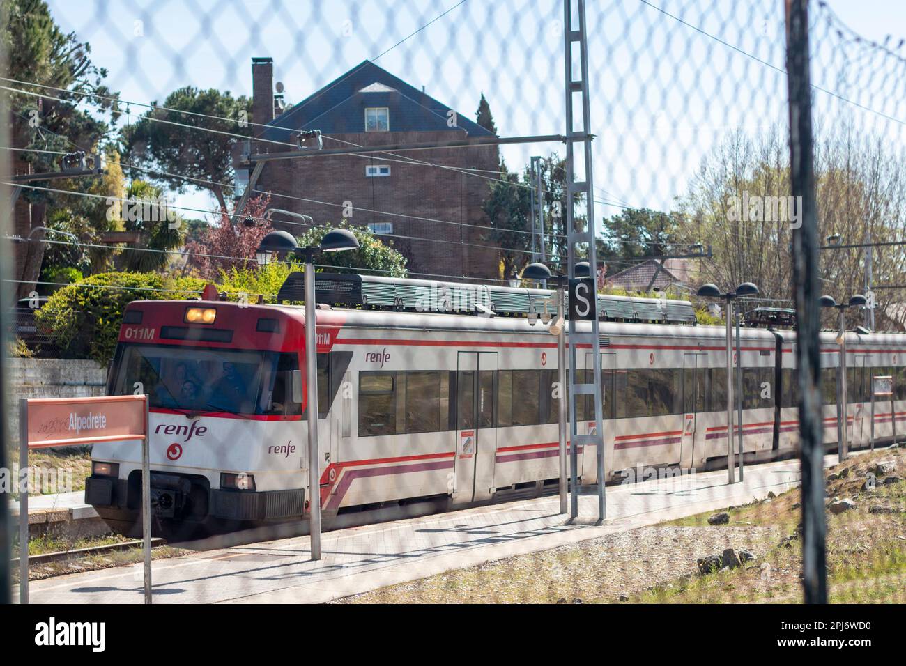 Commuter train of the community of Madrid passing through an open-air ...