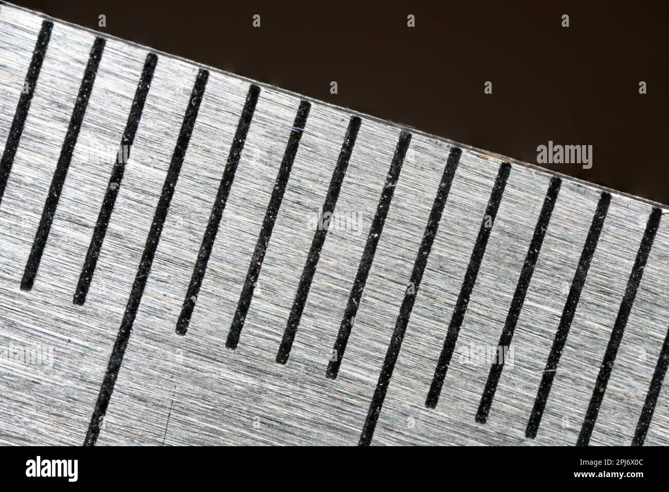 Extreme close-up of a metal ruler with metric measuring scale for ...