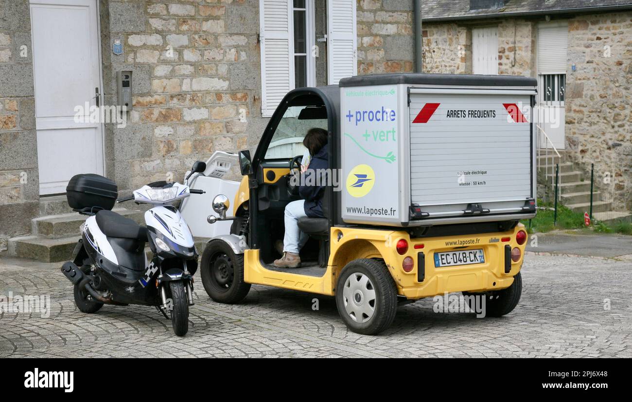 A post girl in the old medieval town of Domfront en Poiraie, Normandy ...