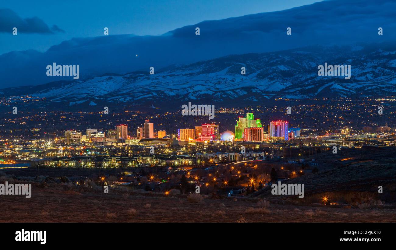 Reno, Nevada, skyline at night with snowy mountains in the distance ...