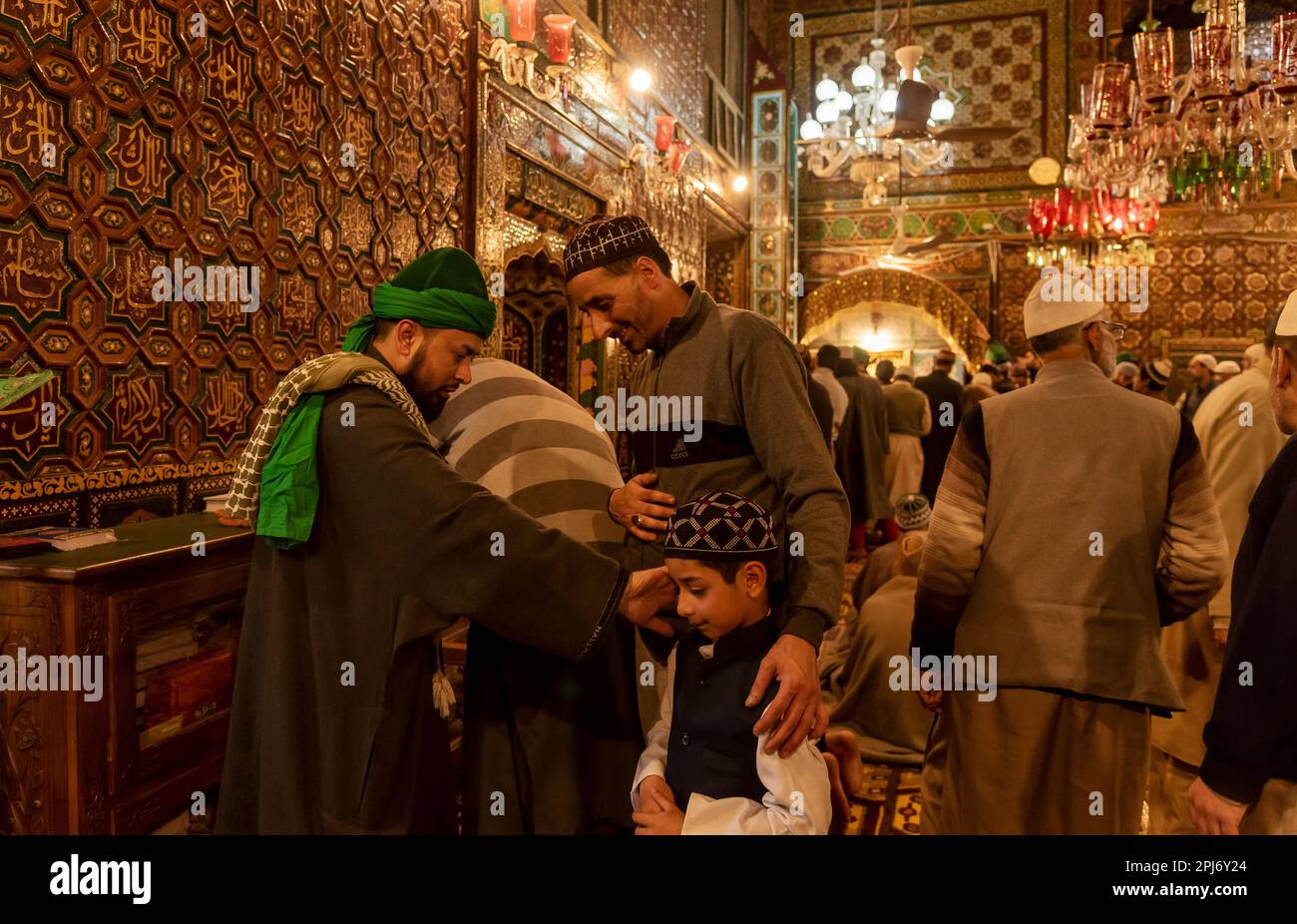 Kashmiri Muslims greet each other after Friday prayers inside a Shrine on the ninth day of ...