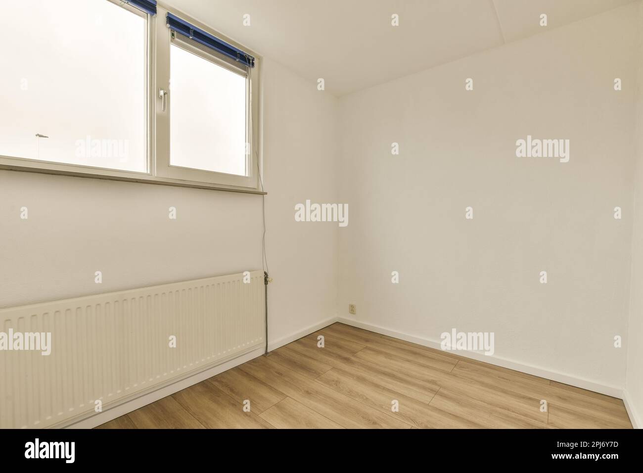 an empty room with white walls and wood flooring on the right side ...