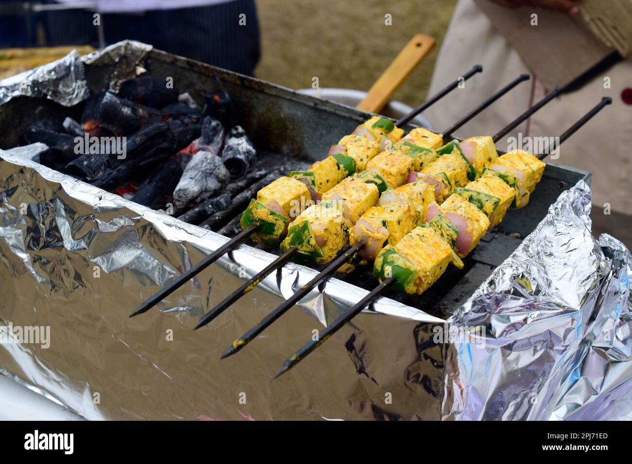 Making of paneer tikka at barbecue Stock Photo - Alamy