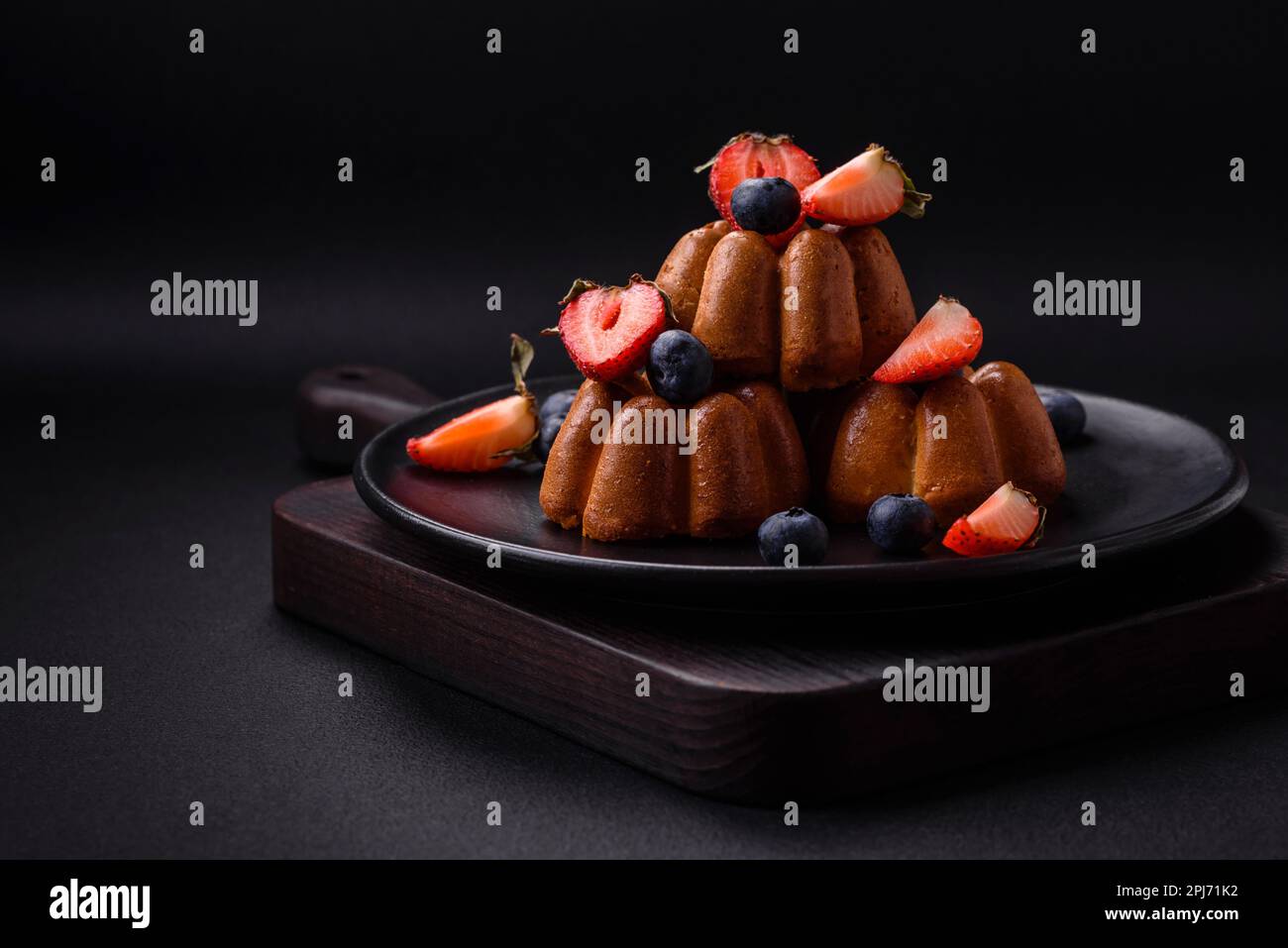 Delicious cupcakes or muffins with raisins and nuts, strawberries and ...