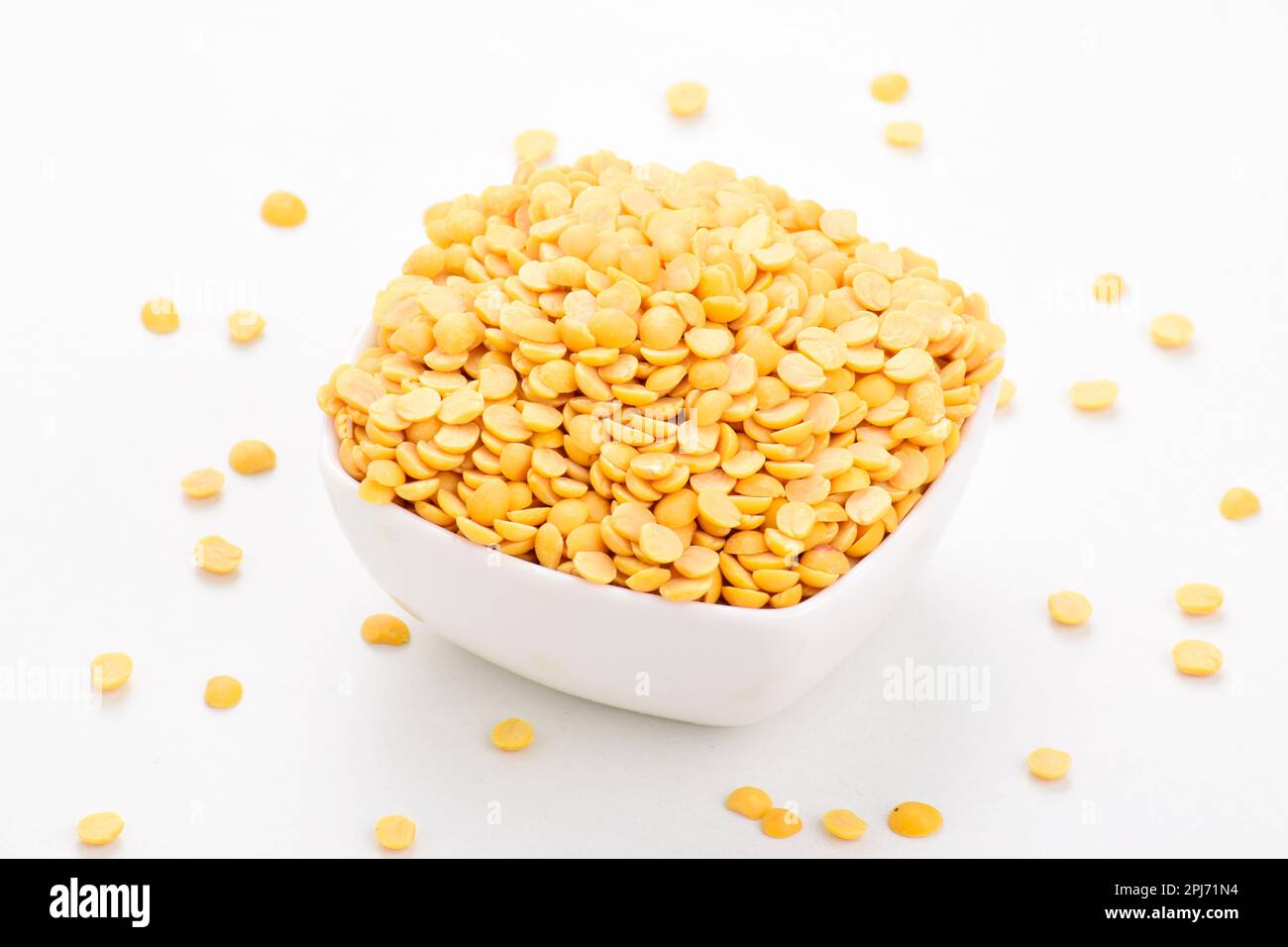 Uncooked chana dal in bowl on white background Stock Photo - Alamy