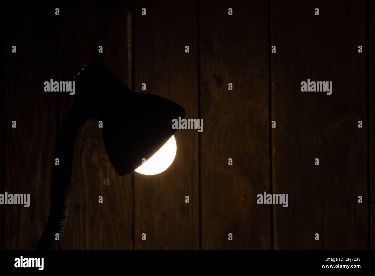 Light bulb illuminates in black hi-res stock photography and images - Alamy
