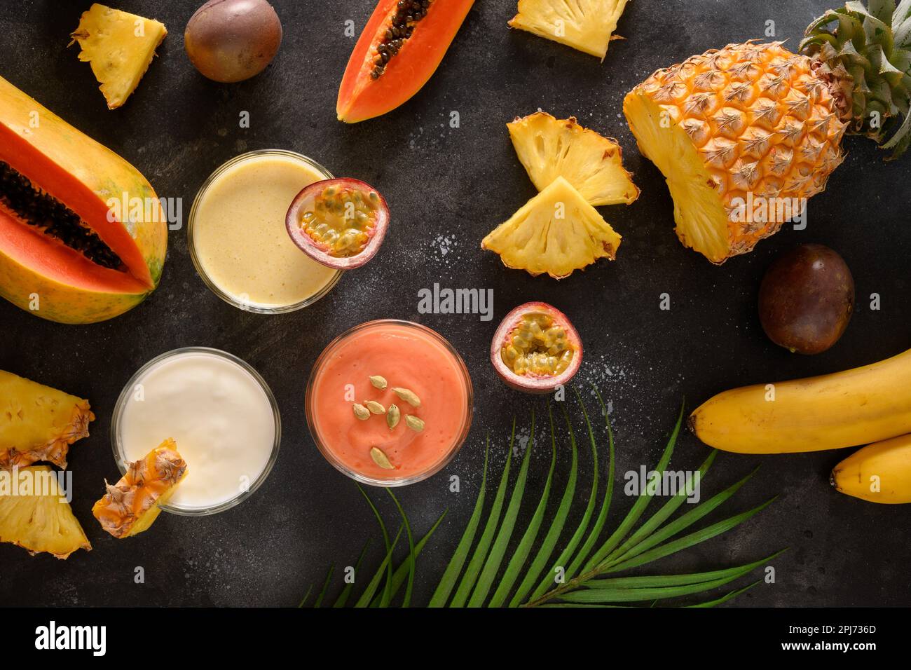 Indian fruits lassi . Pineapple, papaya lassi or smoothie in glasses on ...