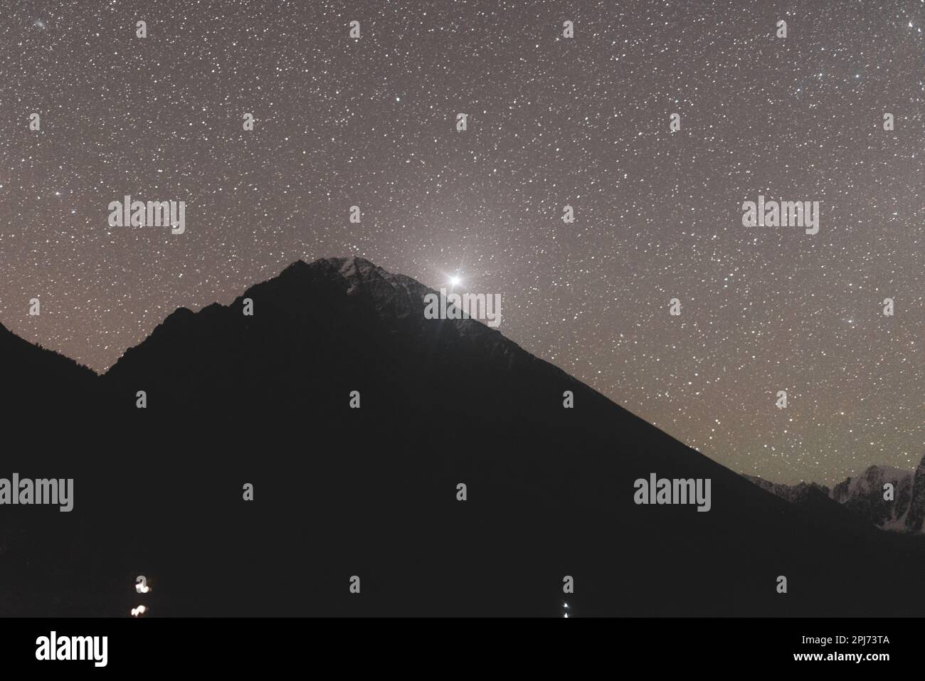 Bright polar star over a mountain with glaciers at night with the light ...