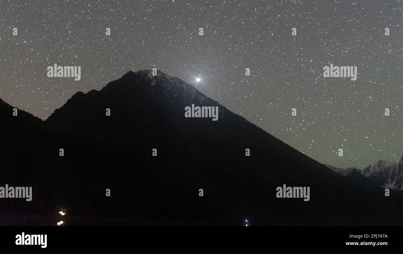 Bright polar star over a mountain with glaciers at night with the light ...