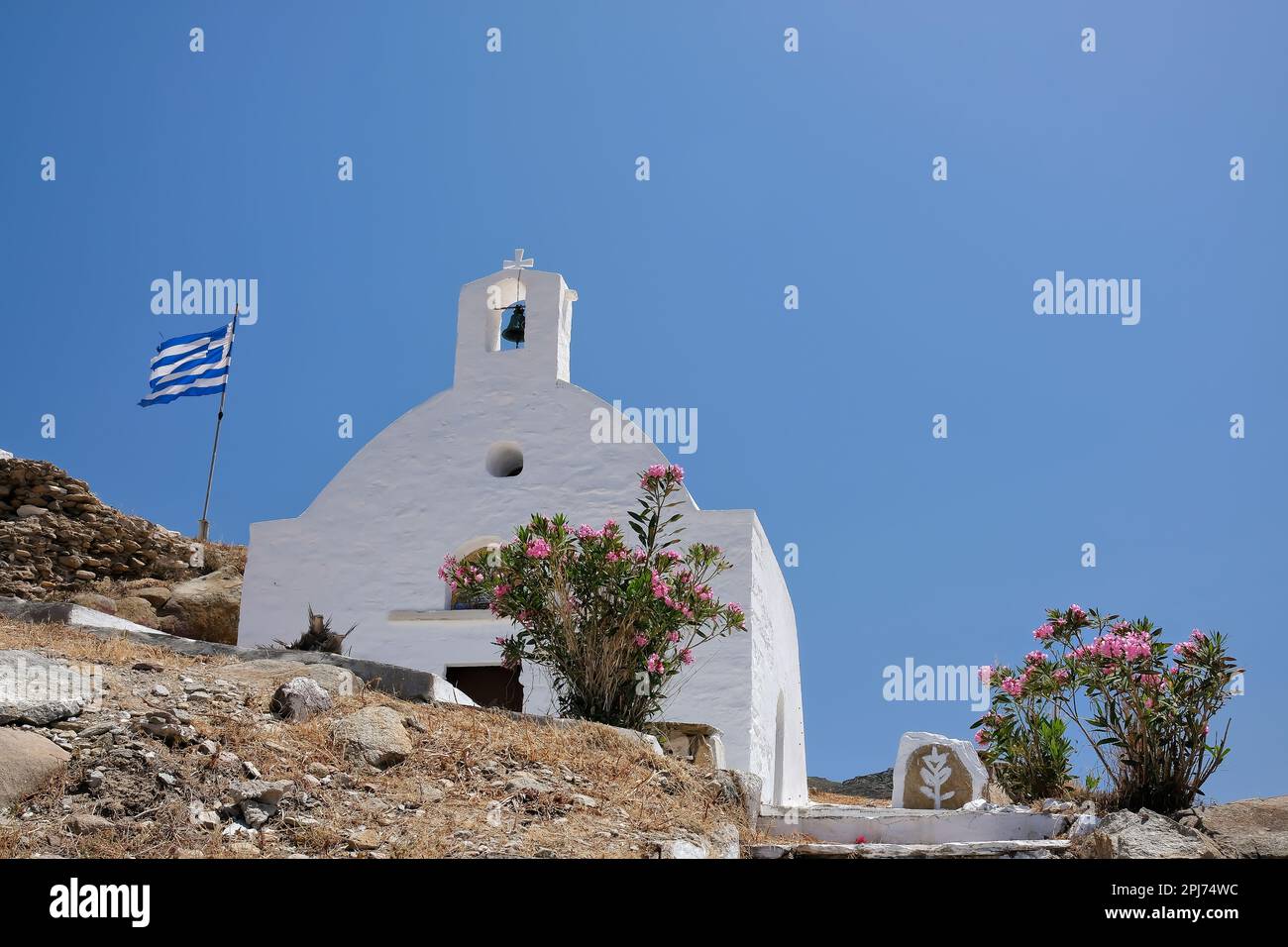 A small whitewashed church at the top of the hill next to the Greek ...