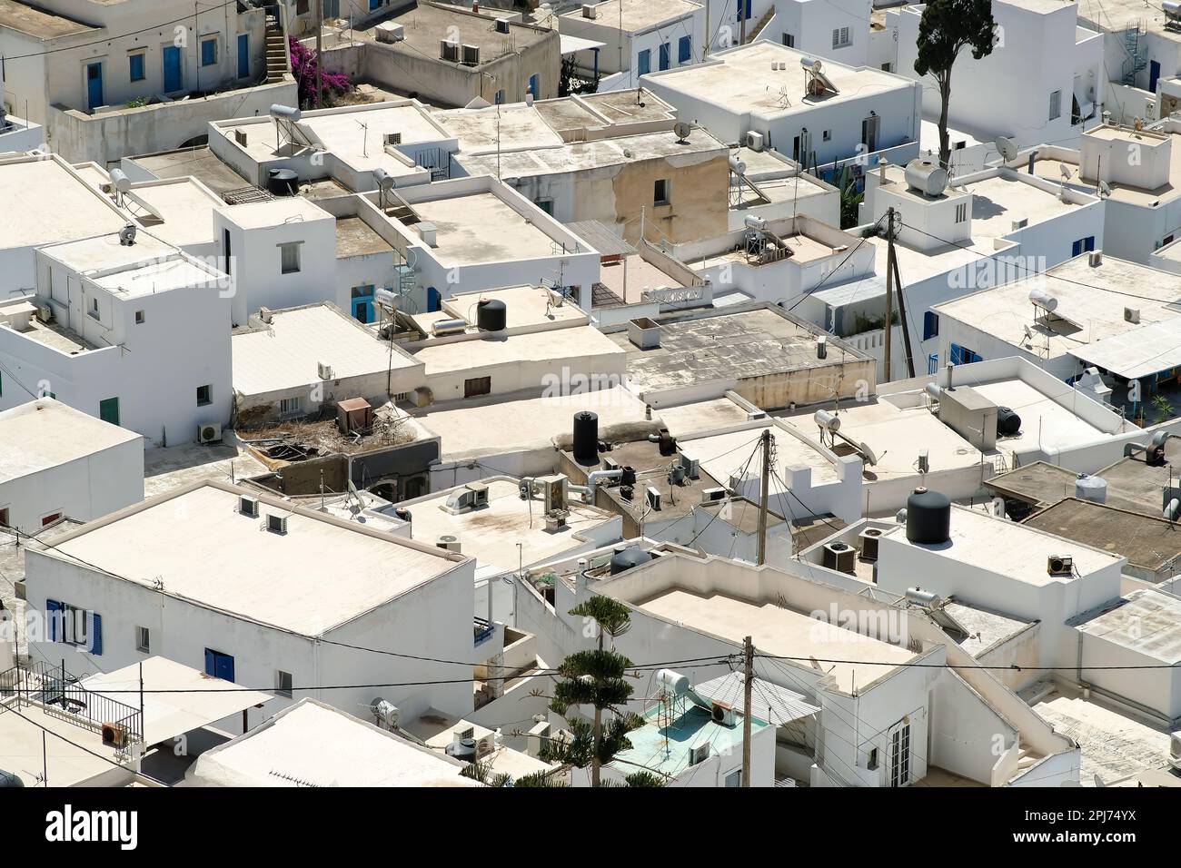 View of the whitewashed residential buildings and houses in Ios Greece ...