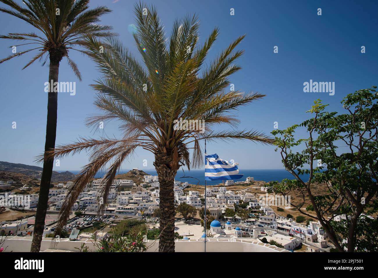 The greek national flag waving in the wind at the top of the village of ...