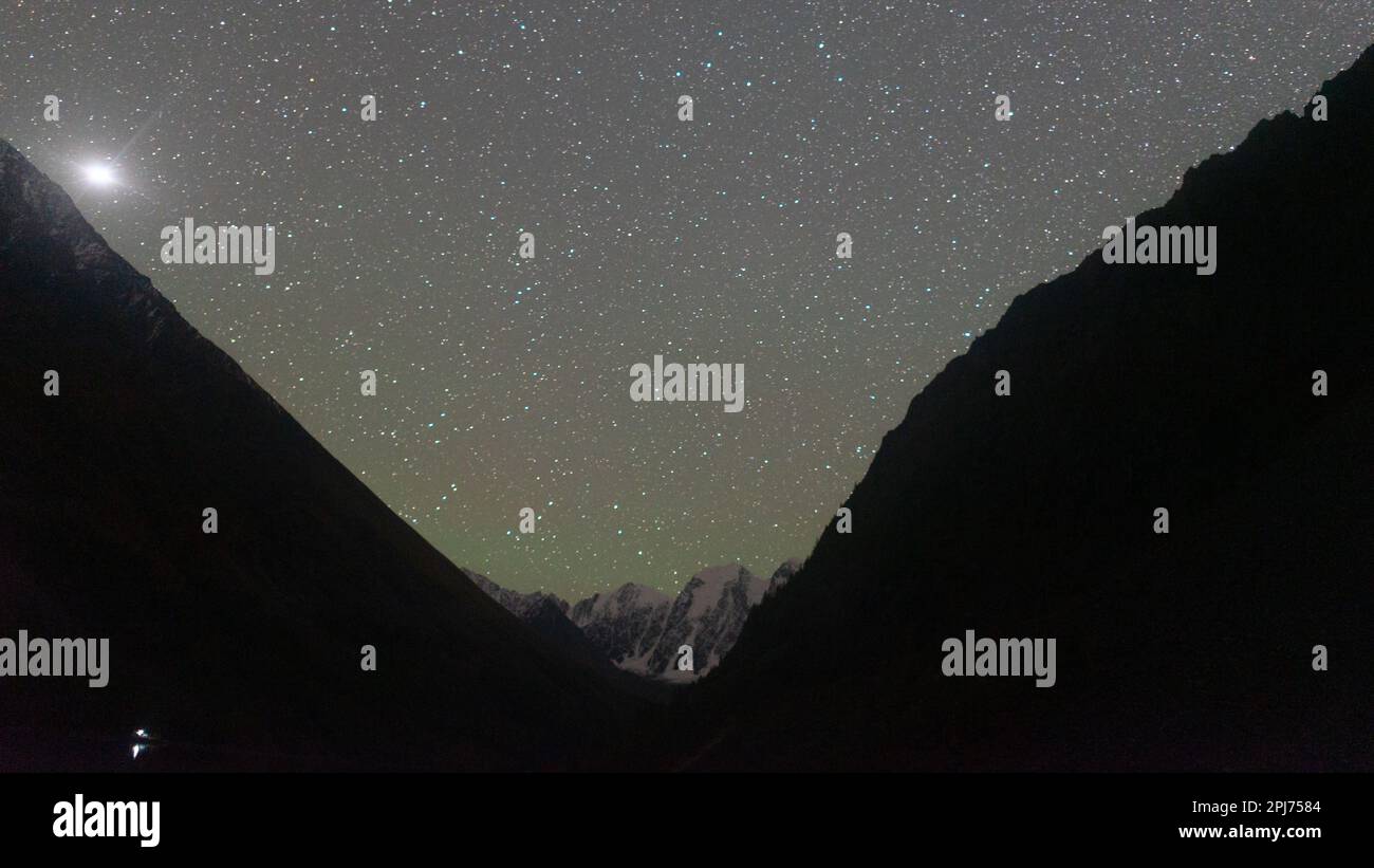 Bright polar star over a mountain with glaciers at night with the light ...