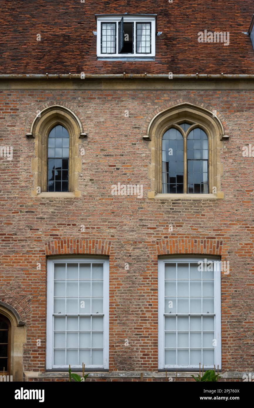Brick wall and old style windows architecture with arch at a college in ...