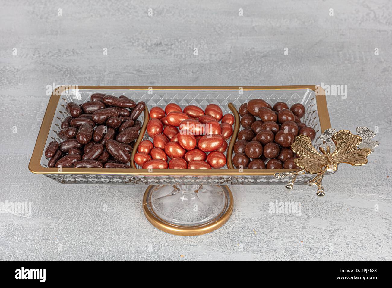 Colorful almond candies in the stylish, crystal candy bowl, almond ...