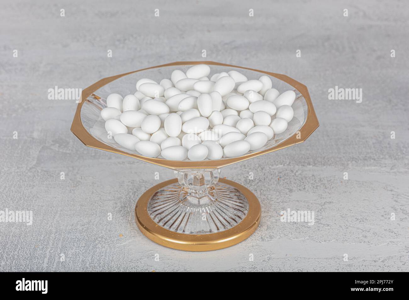 Colorful almond candies in the stylish, crystal candy bowl, almond ...
