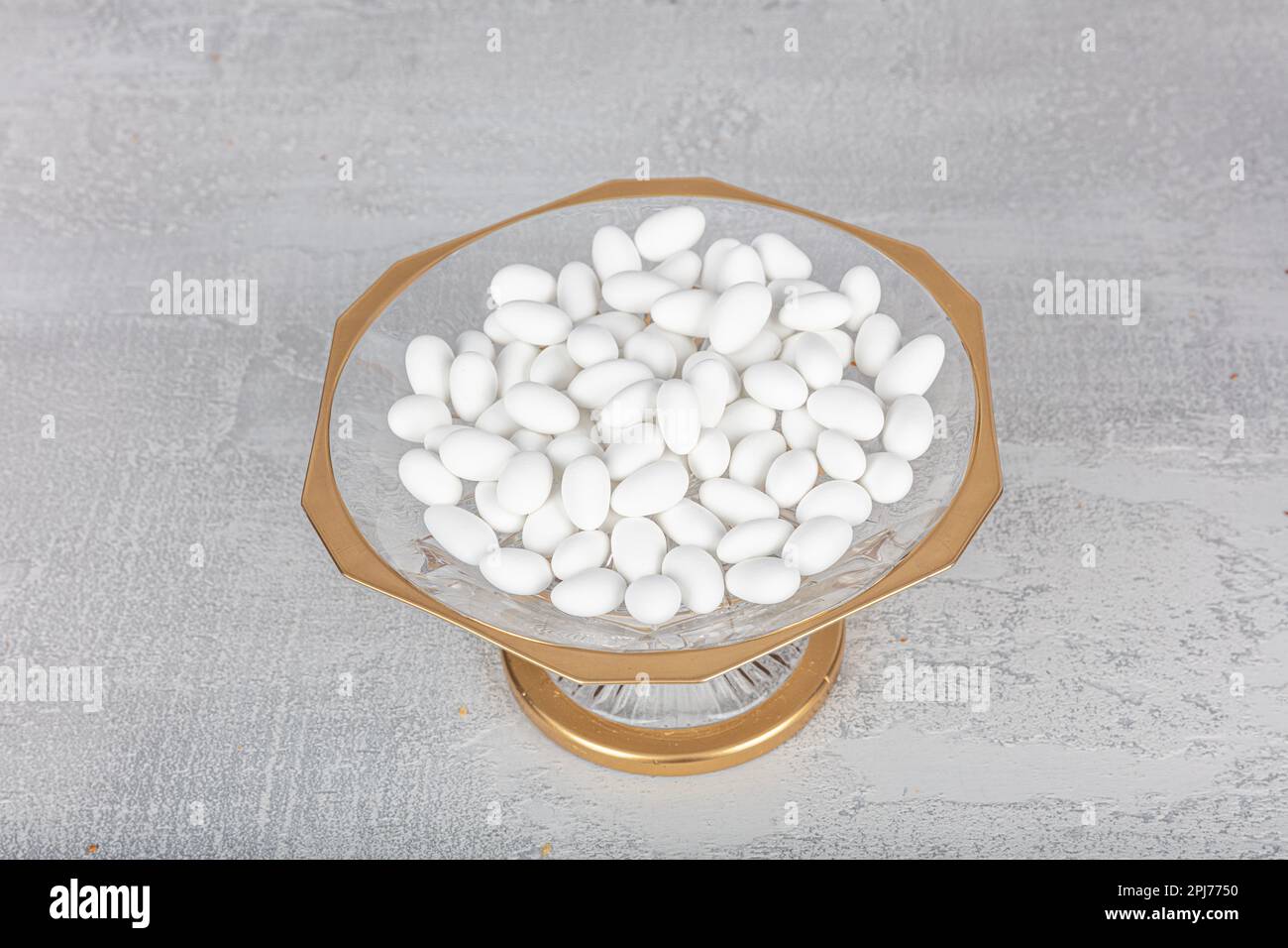 Colorful almond candies in the stylish, crystal candy bowl, almond ...