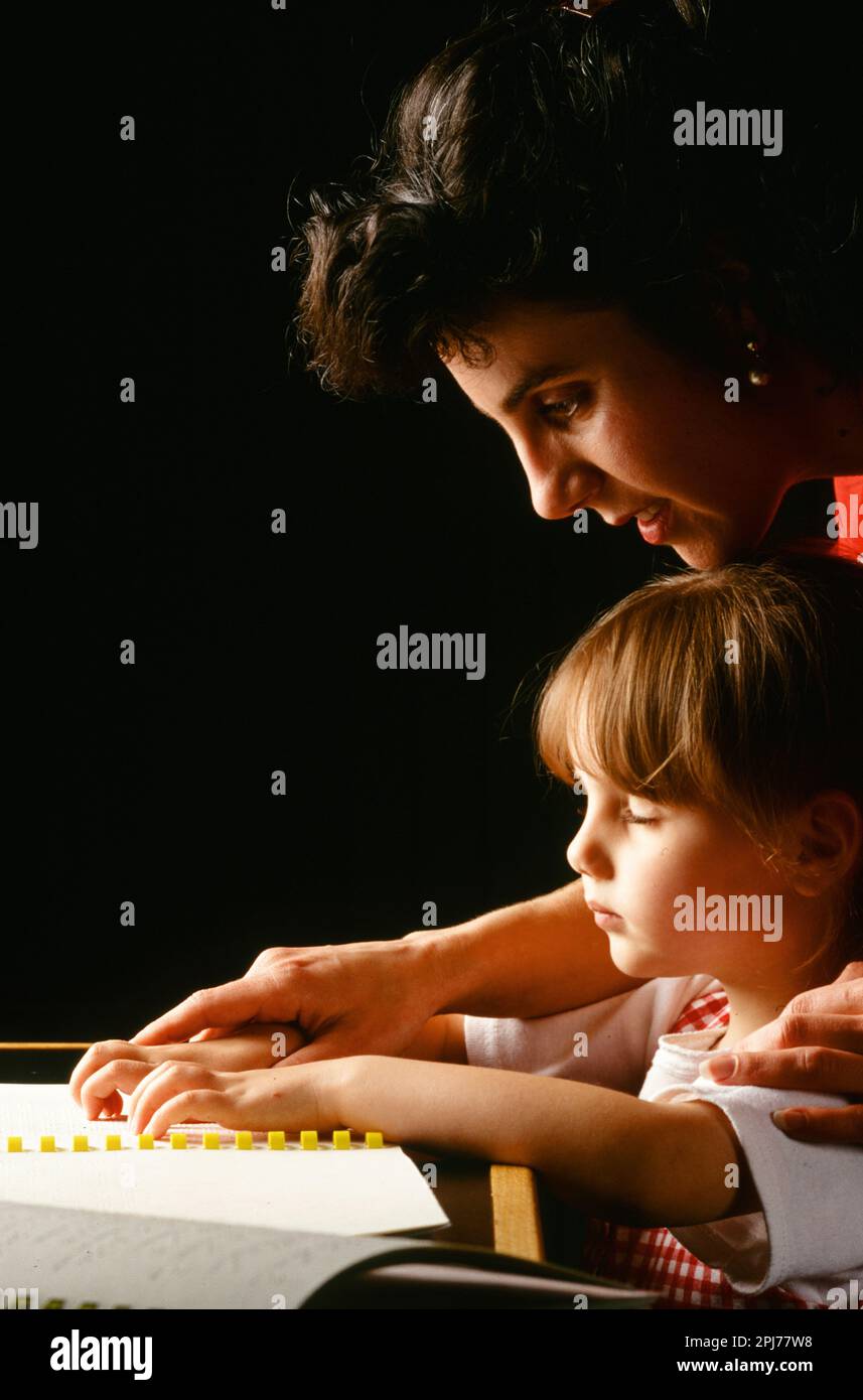 Special education teacher coaching Young child to read braille Stock ... Special education teacher coaching Young child to read braille Stock ...