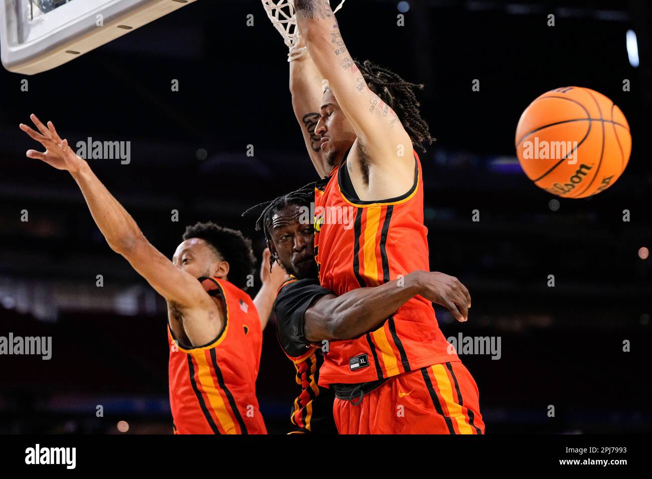 East's Demetre Roberts passes around West's Calb McConnell during the ...