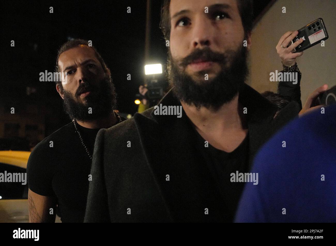 Andrew Tate, left, and his brother Tristan leave a police detention ...