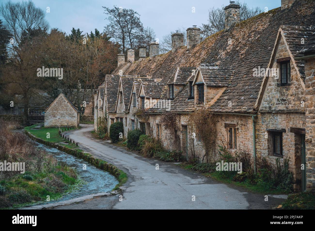 Iconic row of medieval stone built cottages in the picturesque village ...