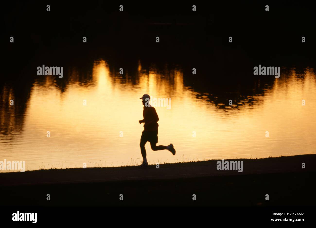 Silhouette of jogger at sunset hi-res stock photography and images - Alamy
